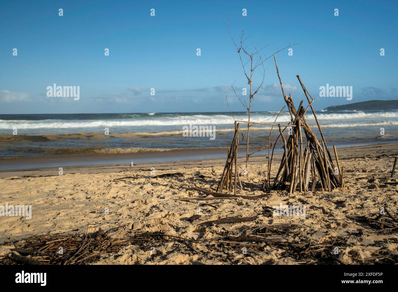 Sticks on beach made into a fort, from a recent storm that washed the ...