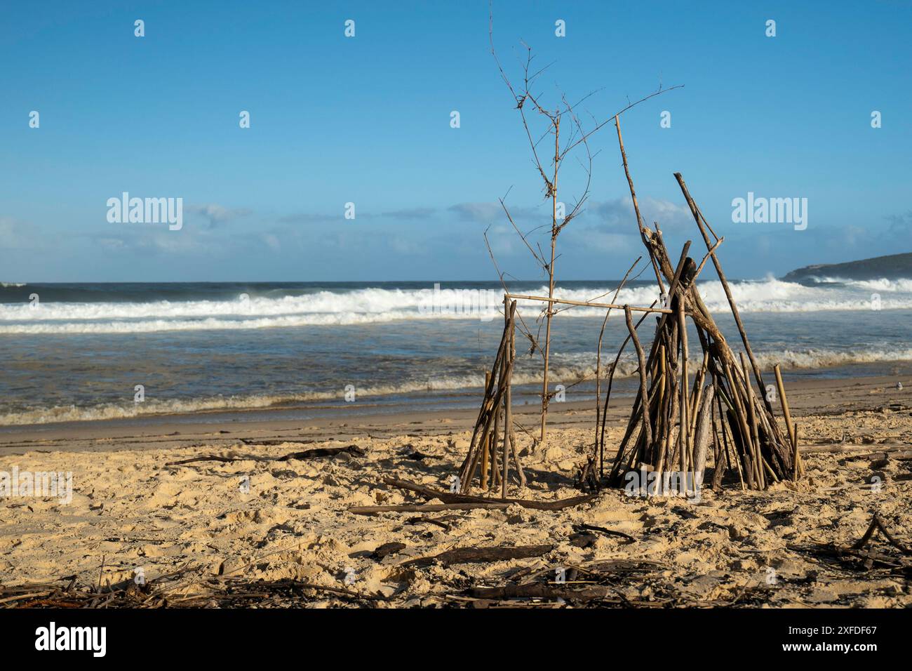 Sticks on beach made into a fort, from a recent storm that washed the ...