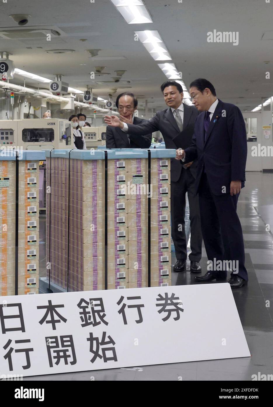 Japan's Prime Minister Fumio Kishida(R) receives an explanation of new ...