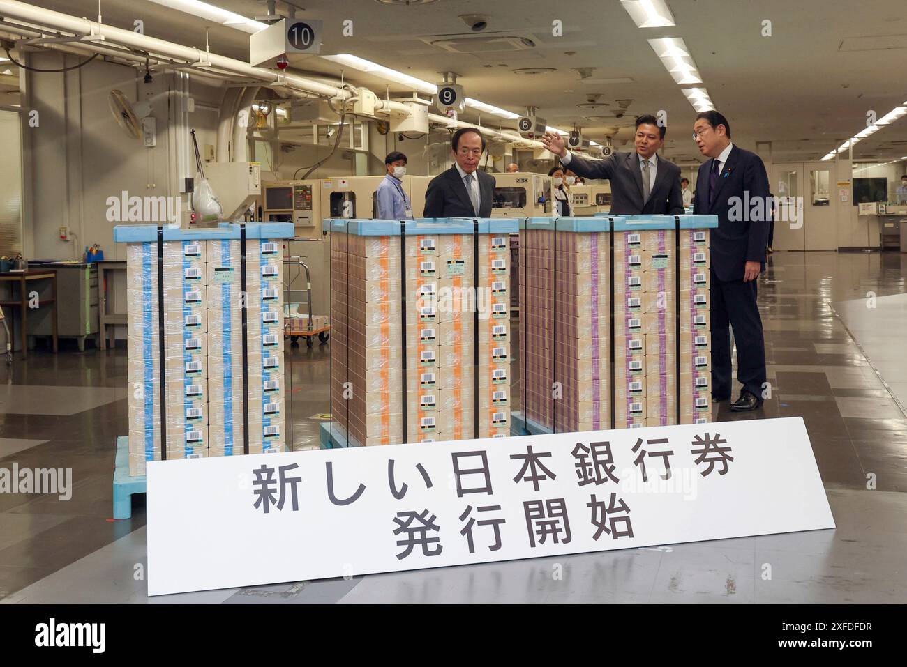 Japan's Prime Minister Fumio Kishida(R) receives an explanation of new ...