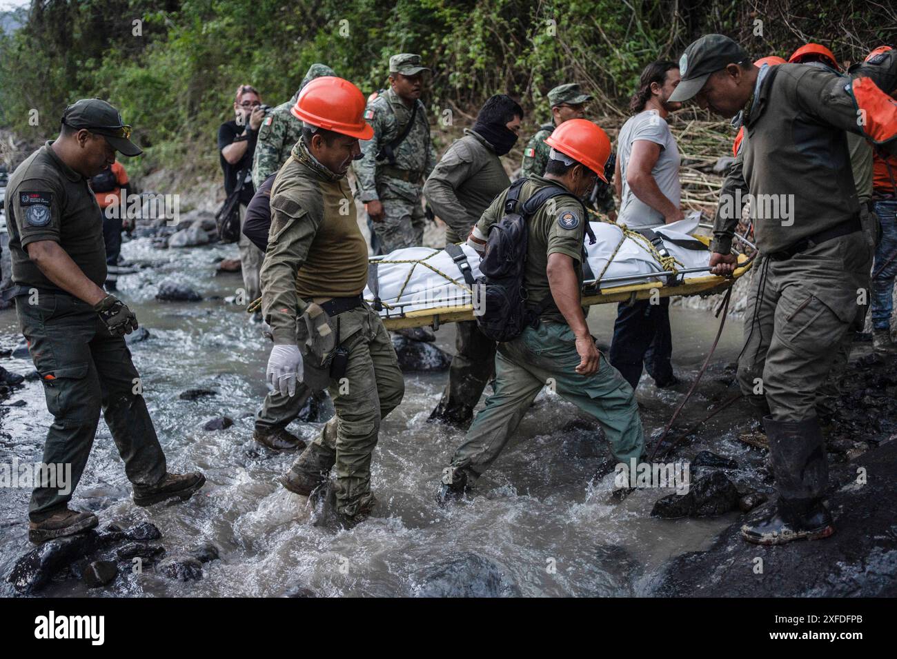 Rescuers recover the body of a policeman who state authorities said ...