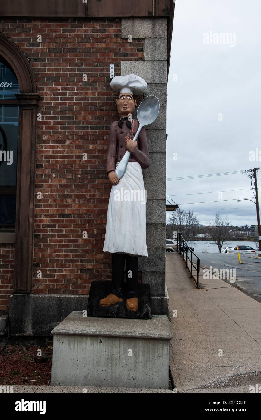 Statue of a chef carrying a spoon at Isaac's Way restaurant on Queen ...