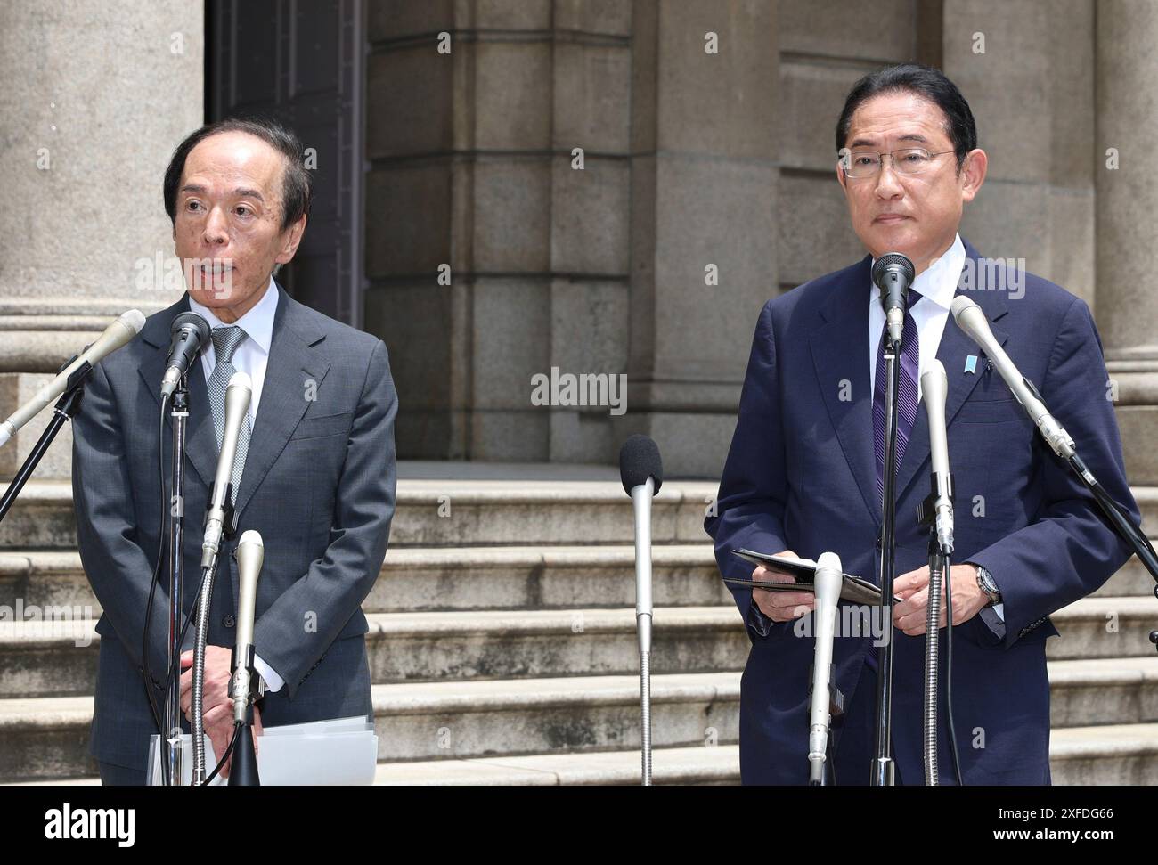 Japan's Prime Minister Fumio Kishida(R) and Bank of Japan's governor ...