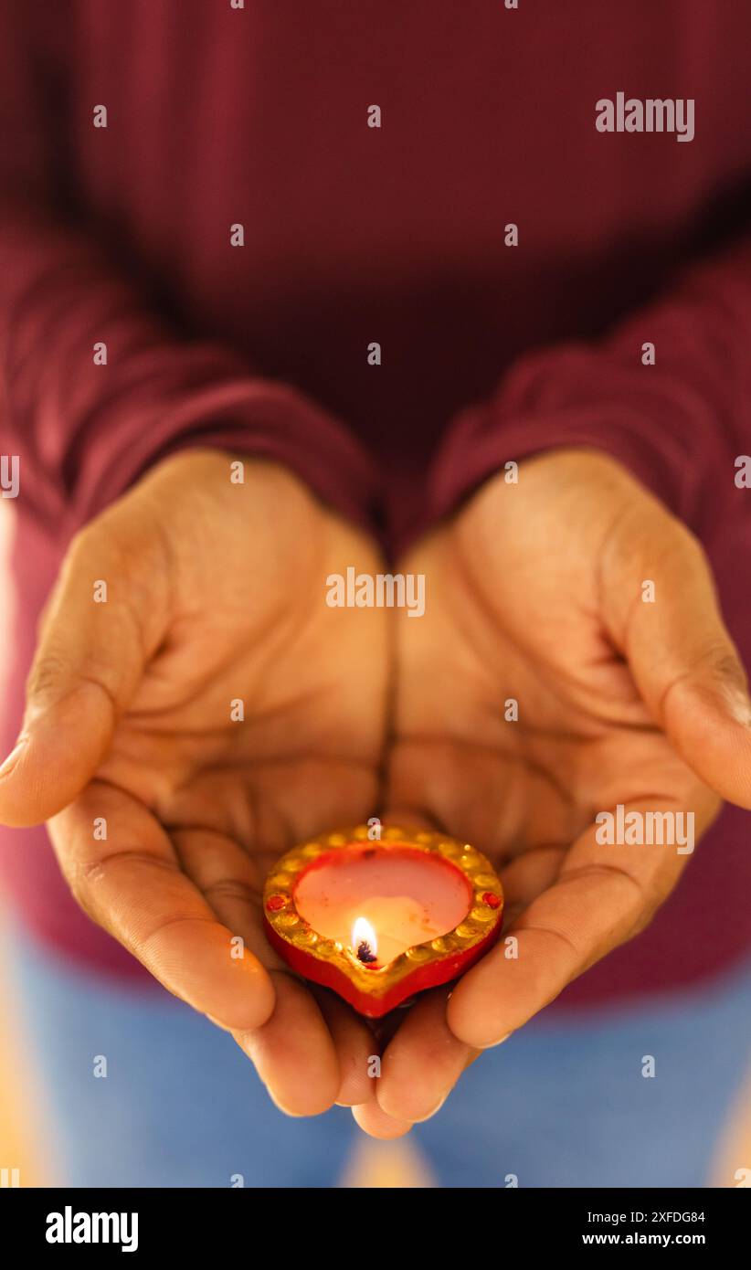 Holding lit diya, person celebrating traditional Indian diwali festival ...