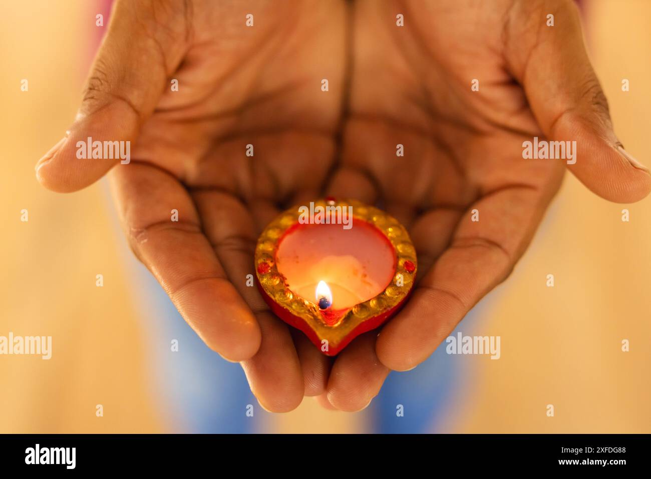 Holding decorative diya, hands showcasing traditional Indian diwali ...