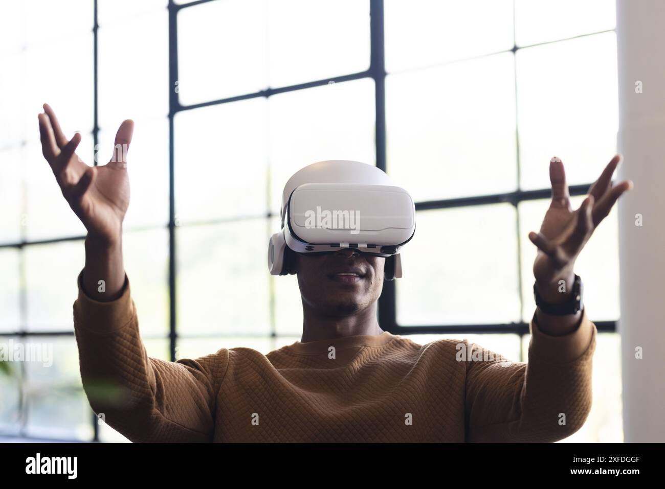 Using VR headset, man experiencing virtual reality in modern office ...