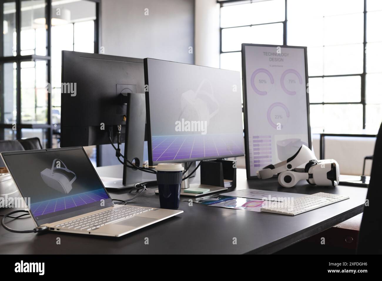 On office desk, laptop, VR headset, and technology design charts in ...