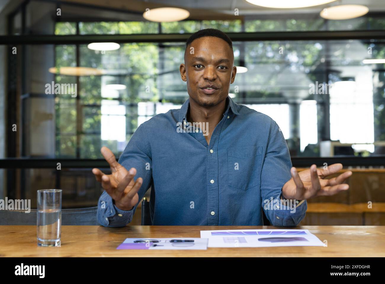Businessman explaining project with documents and glass of water on ...