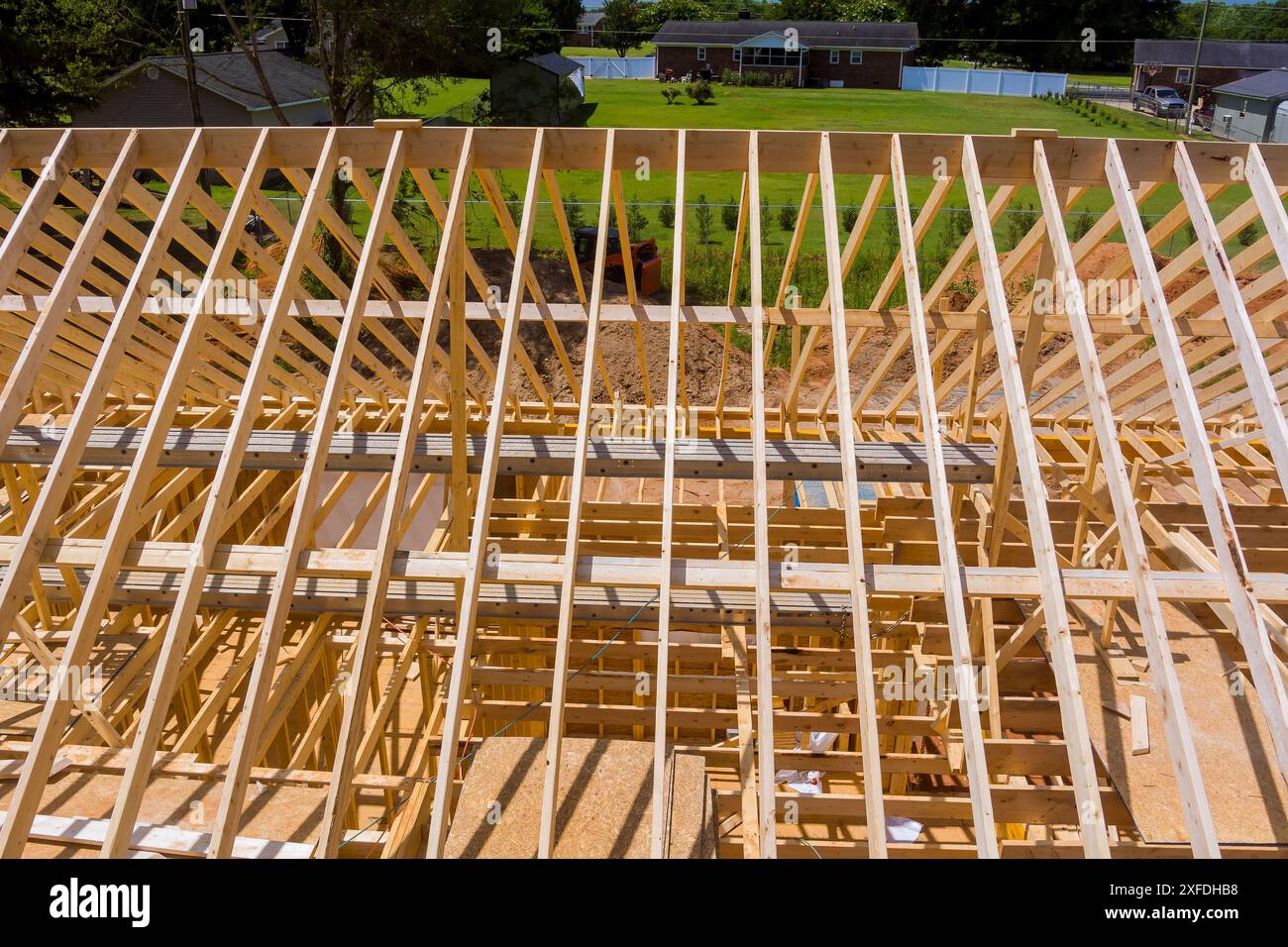 Wooden roofing truss frame is installed by house under construction ...