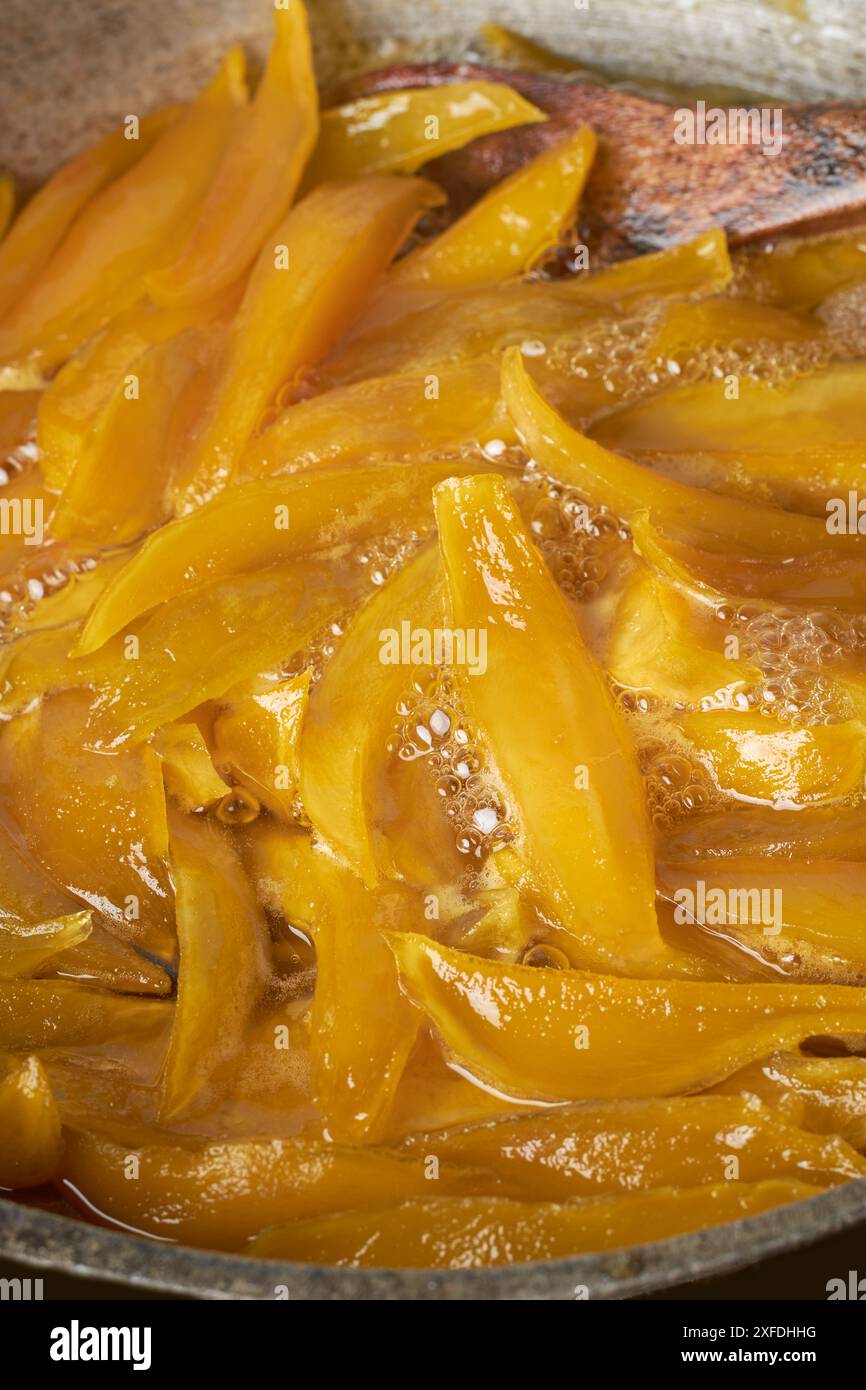 making mango jam or marmalade, raw mango slices boiled with sugar syrup ...