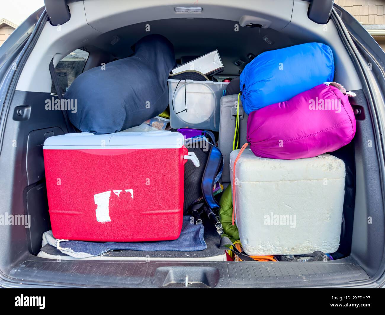 Full van packed for a camping trip with the back open Stock Photo - Alamy