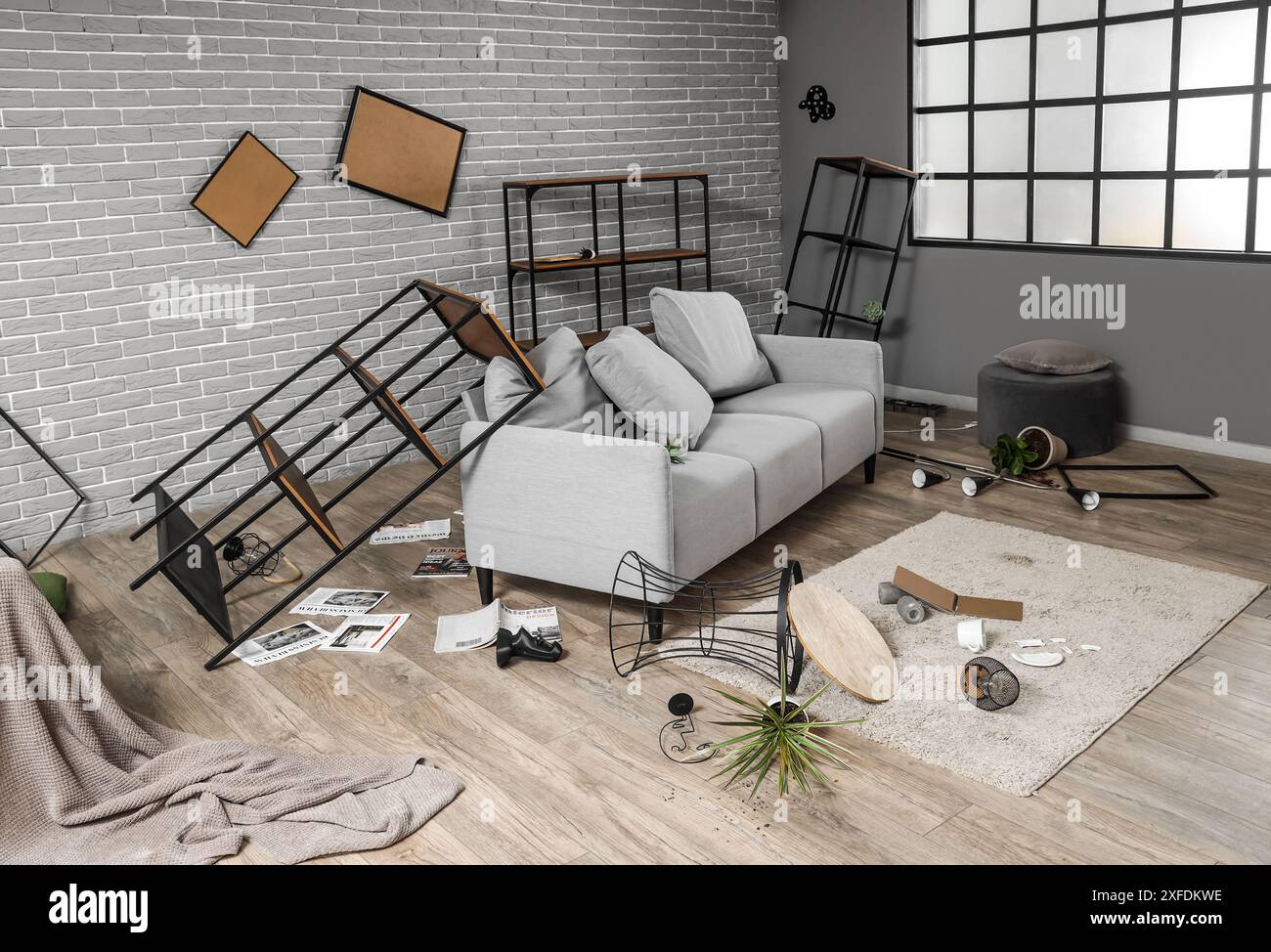 Interior of messy living room with sofa and shelf units Stock Photo - Alamy