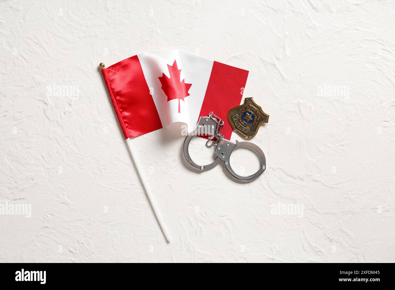 Police badge, handcuffs and Canadian flag on light background Stock ...