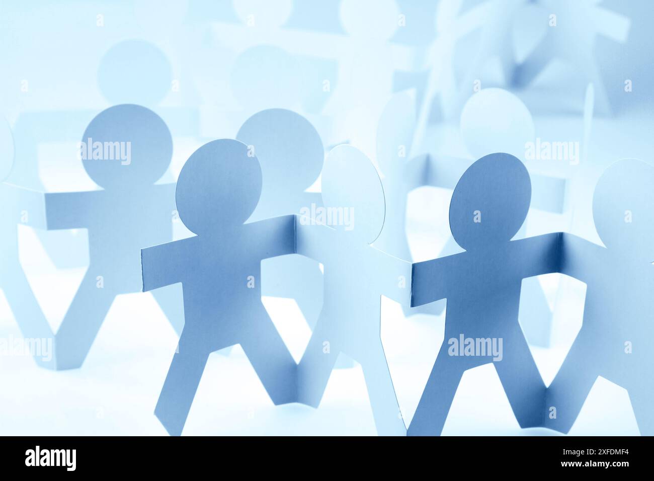 Team of paper chain people united together holding hands Stock Photo ...