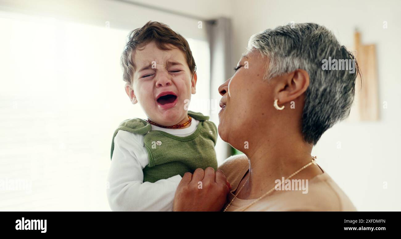 Home, granny and hug for crying baby, sad and comfort in living room, compassion and love ...