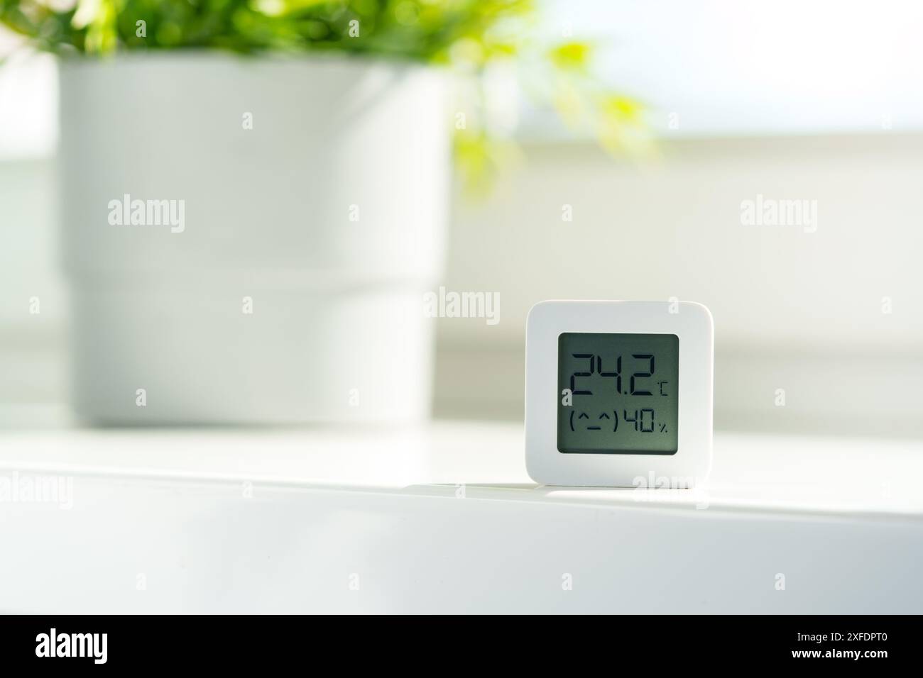 White Digital Thermometer Displaying Room Temperature and Humidity ...
