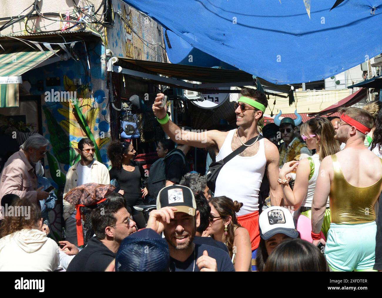 Israelis wearing costumes at the Carmel market during Purim festival ...