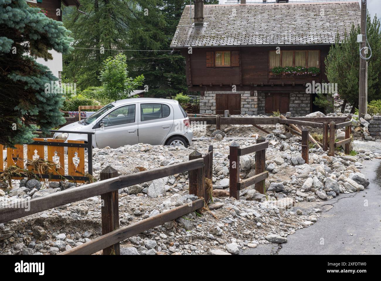 Overflowing of a river, flooding and landslides among houses of a ...