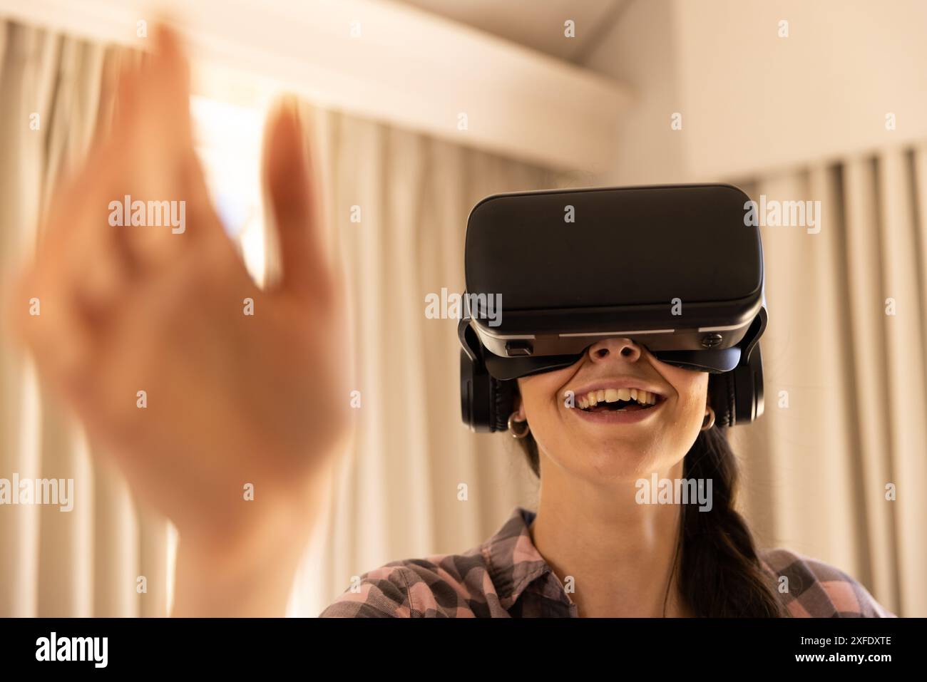 Using VR headset, woman smiling and interacting with virtual environment Stock Photo - Alamy