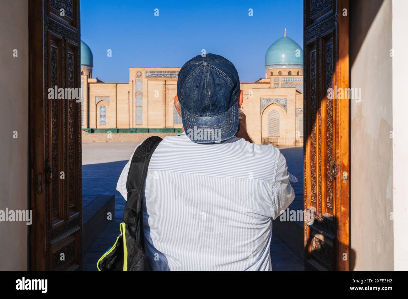 back of a male tourist photographer photographing historical landmarks ...