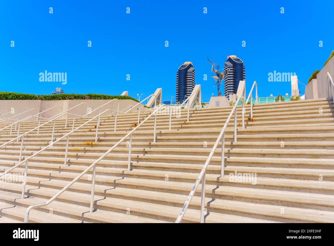 Wide staircase with handrails leading up to modern skyscrapers and San ...