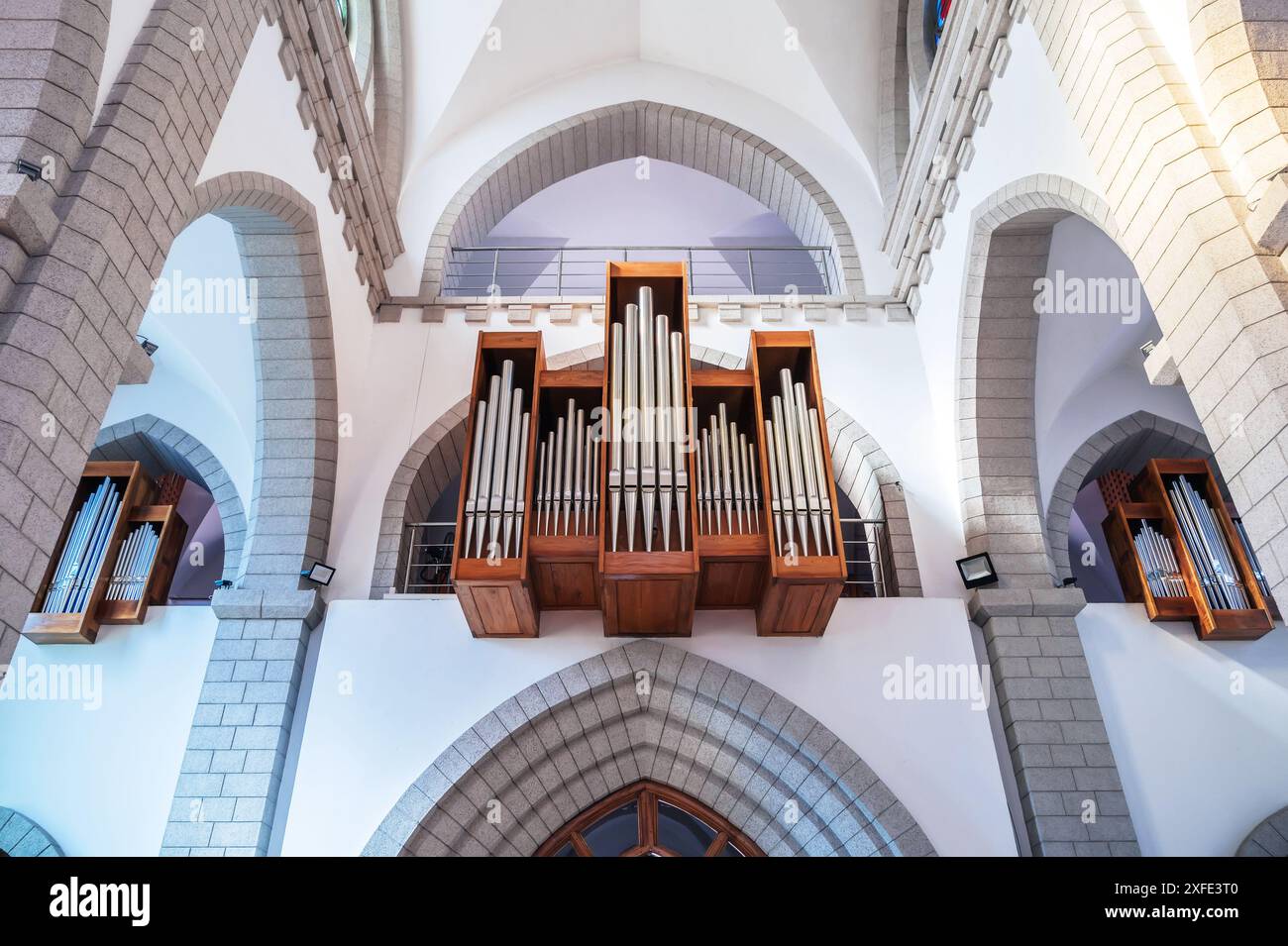 pipes of a church organ inside the interior of a Christian Catholic ...