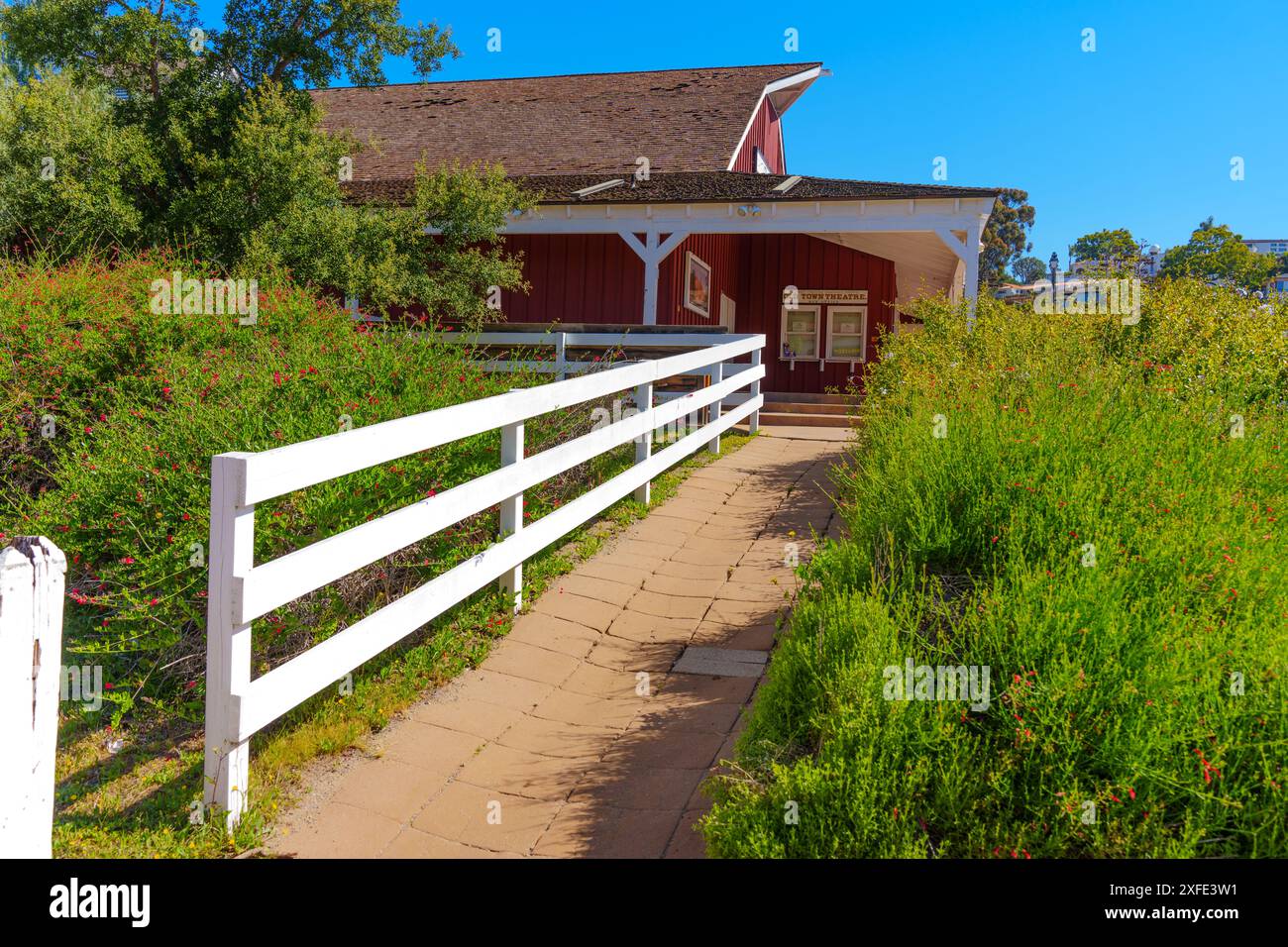San Diego, California - April 16, 2024: Red barn with a white fence and ...