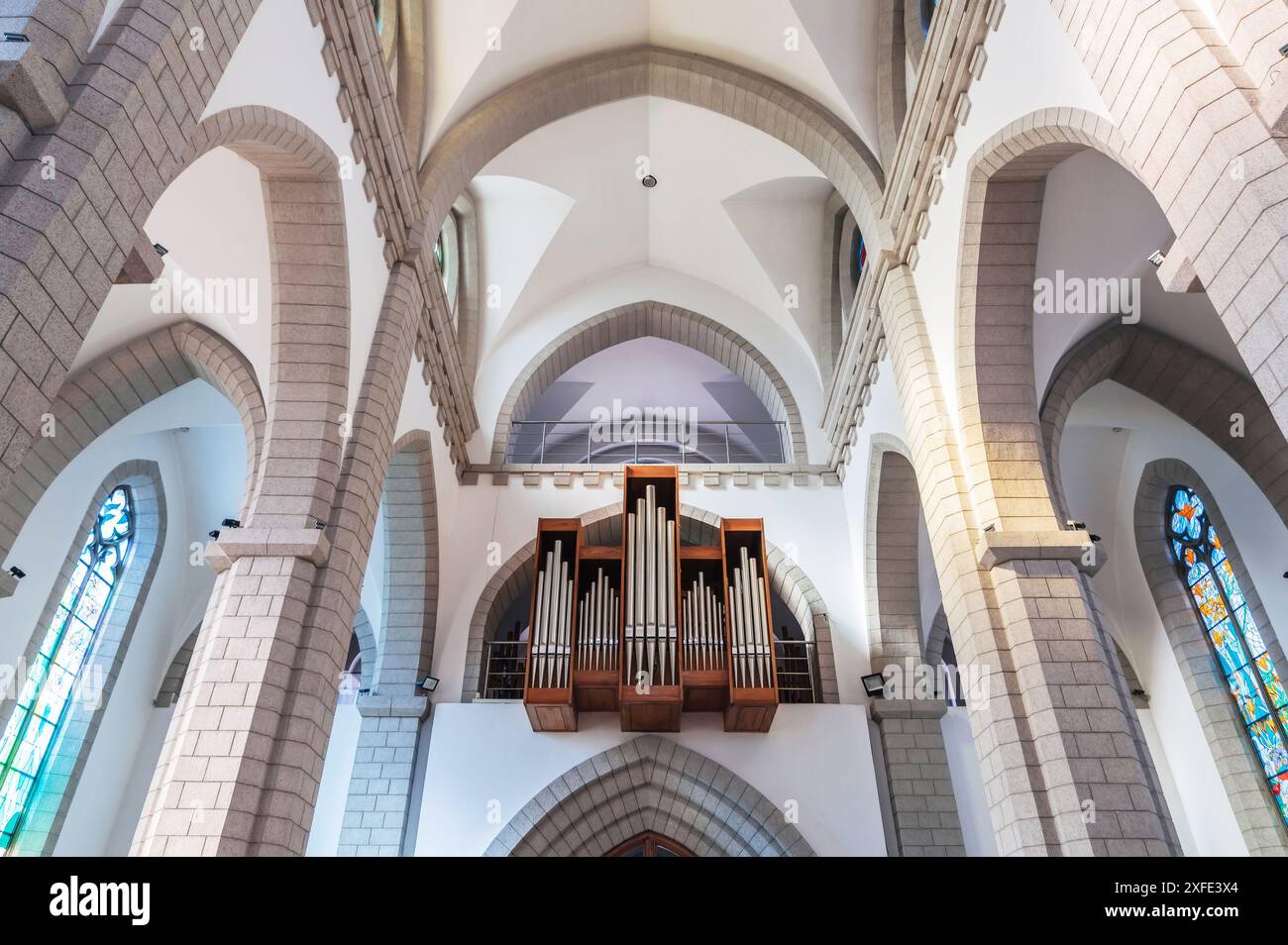 interior of a Christian Catholic church with organ pipes on the wall ...