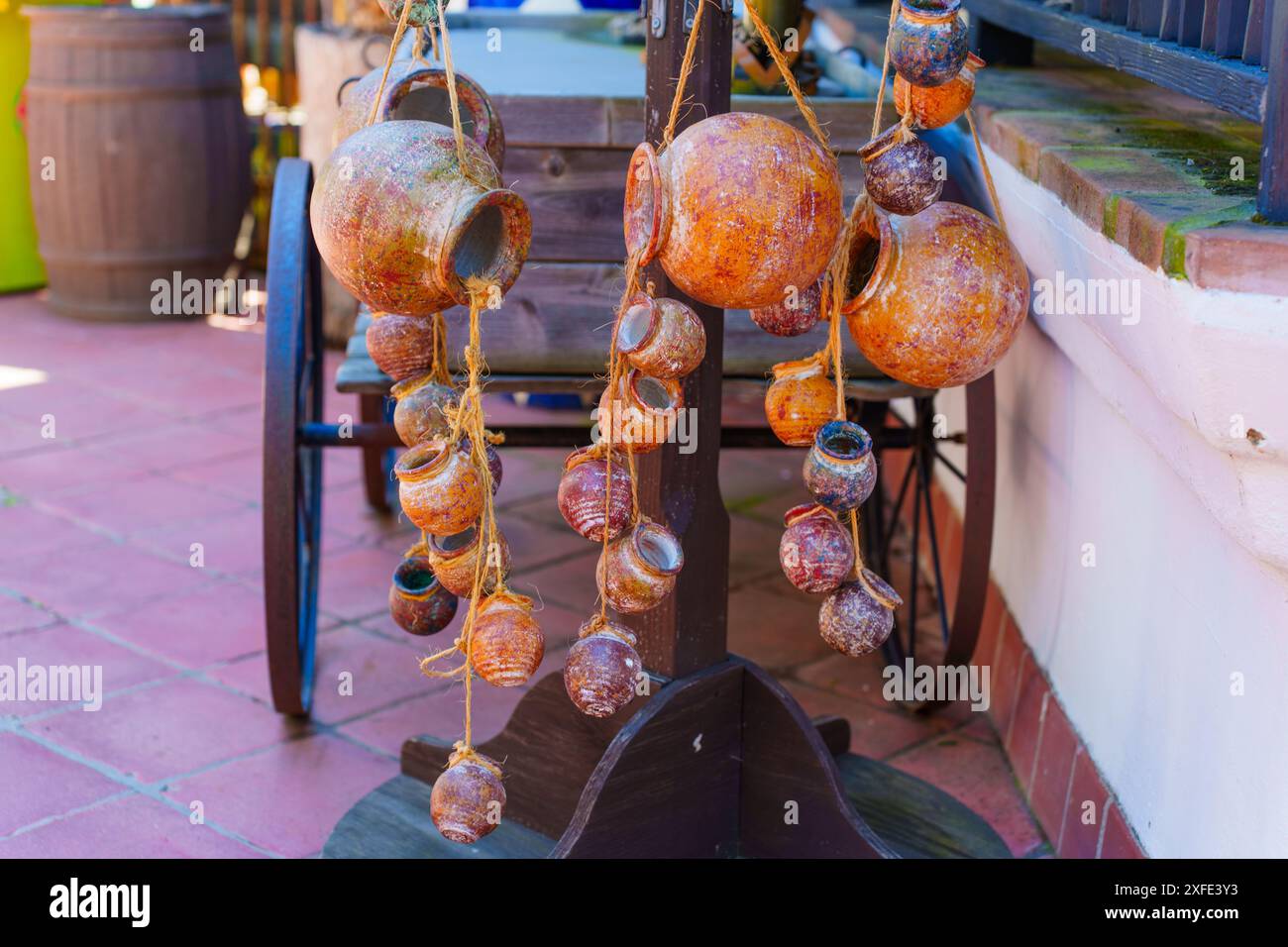San Diego, California - April 16, 2024: Hanging clay pots of various ...