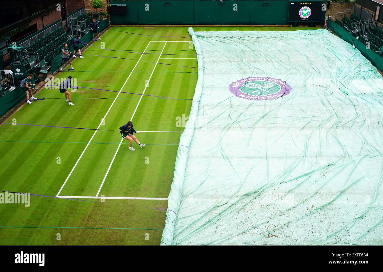 Ground staff cover court 18 on day three of the 2024 Wimbledon ...