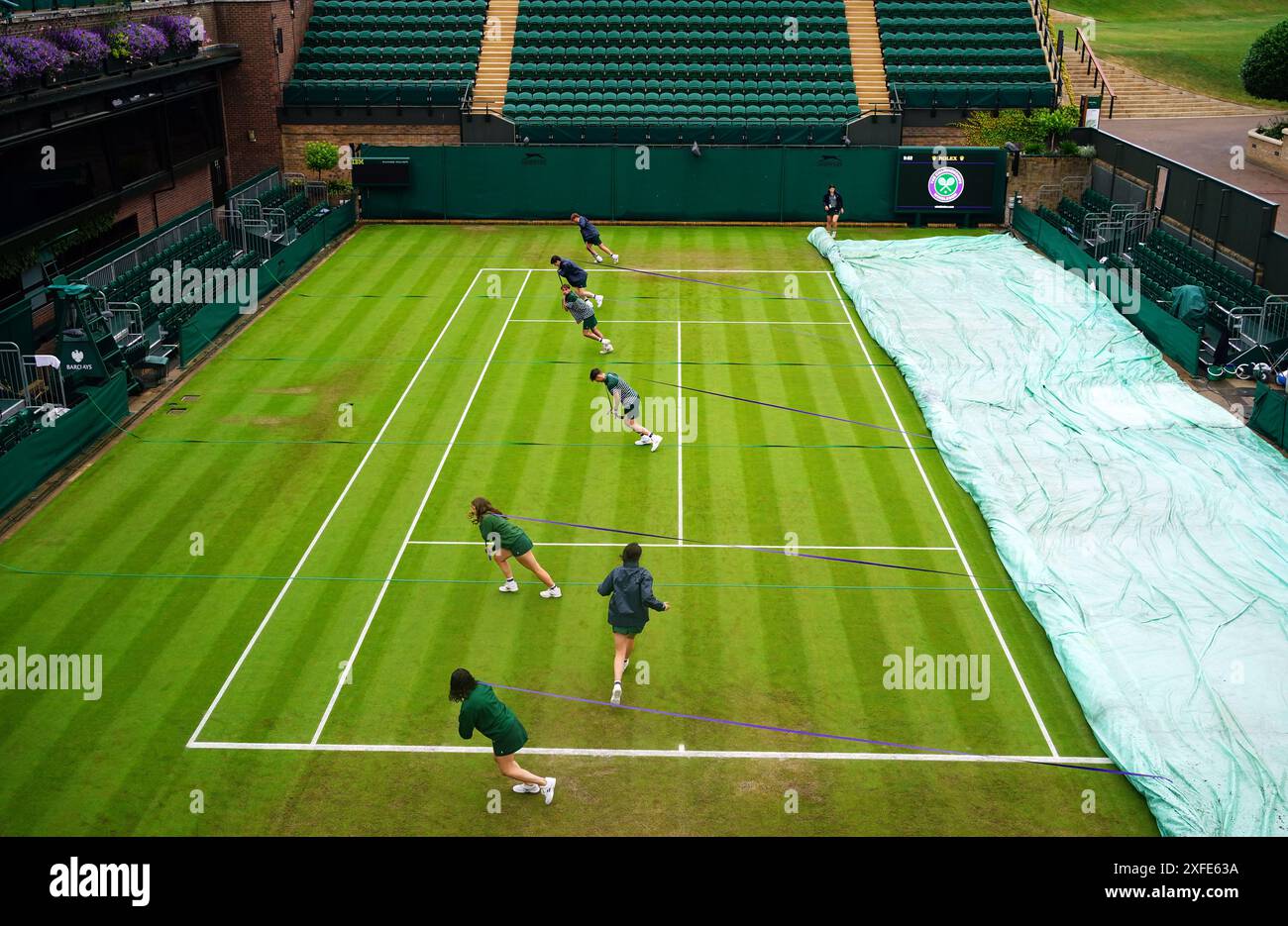 Ground staff cover court 18 on day three of the 2024 Wimbledon ...