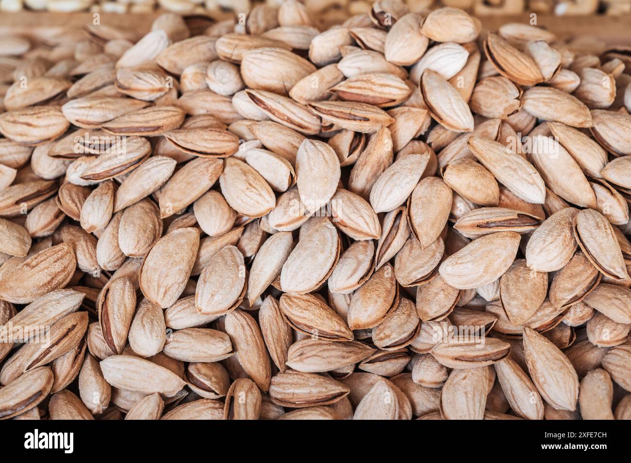 background with unpeeled almond kernels in a shell on a bazaar counter ...
