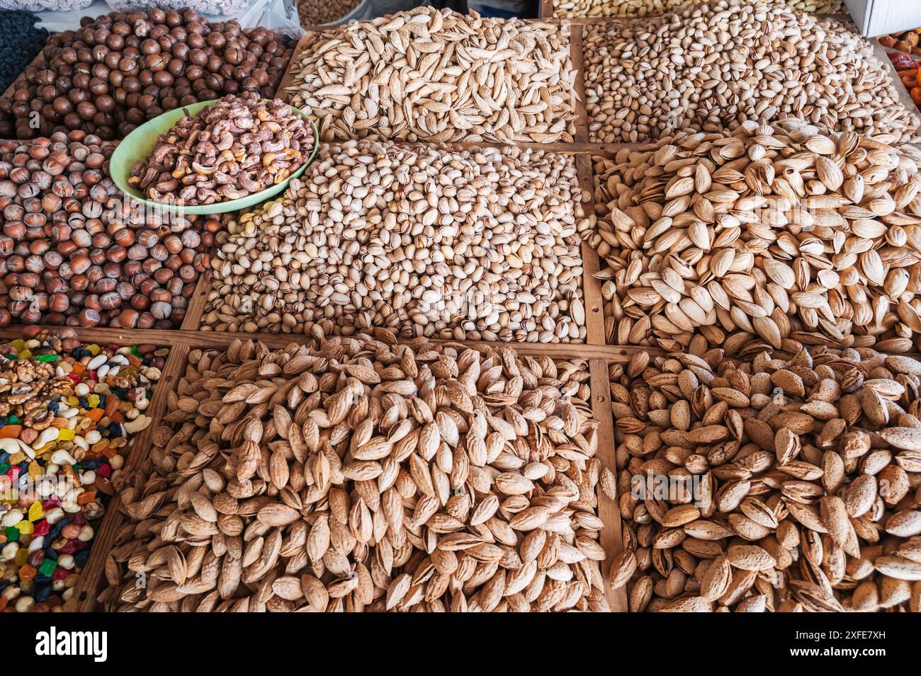 assortment of different variety nuts and dried fruits on counter at the ...