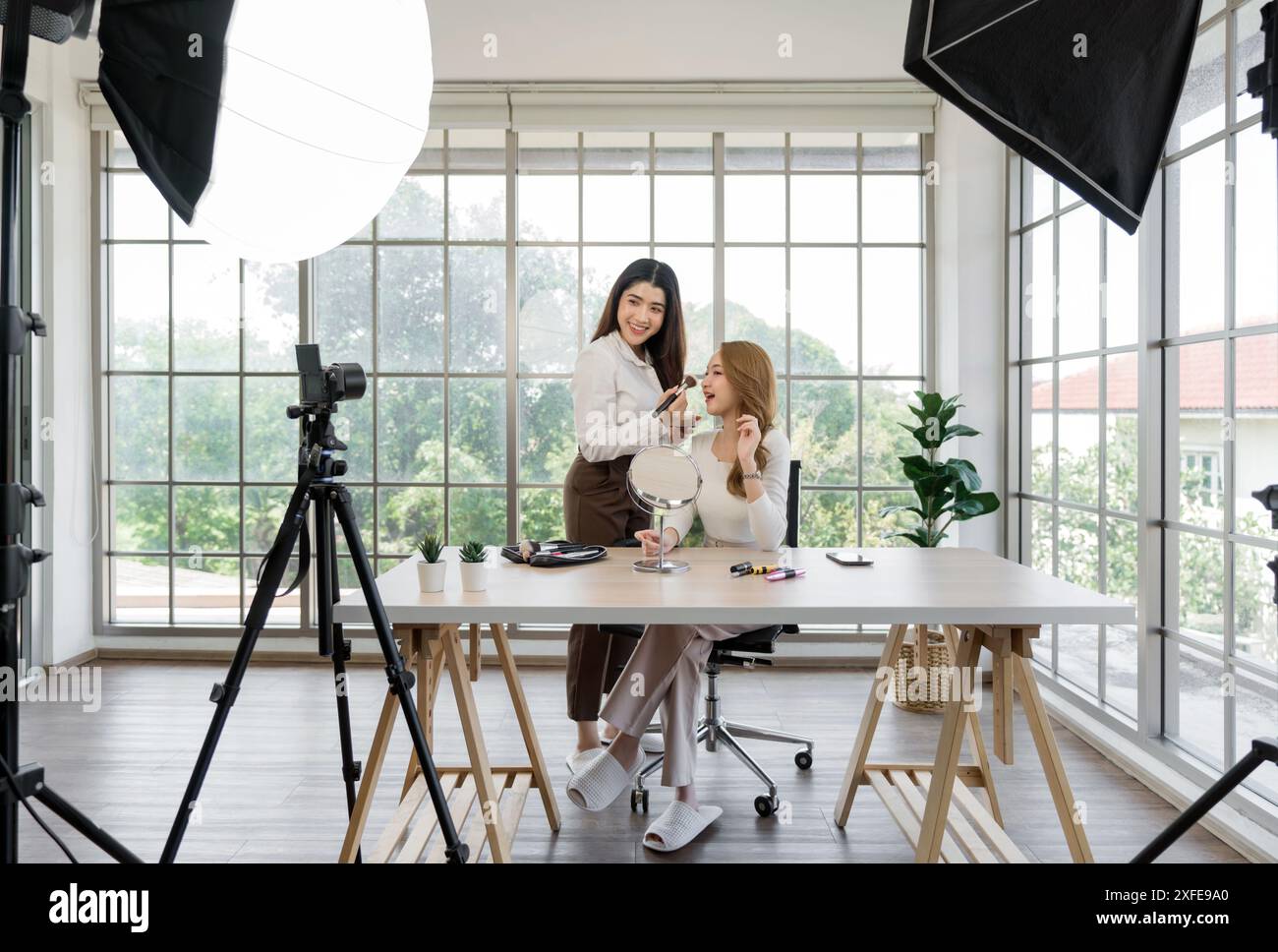 Two asian women creating content for social media. They are using a ...
