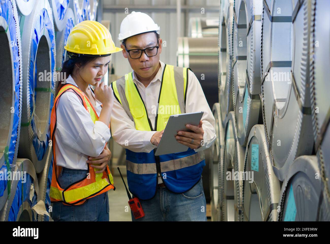 Senior engineer manager trains new employee within the metal sheet ...
