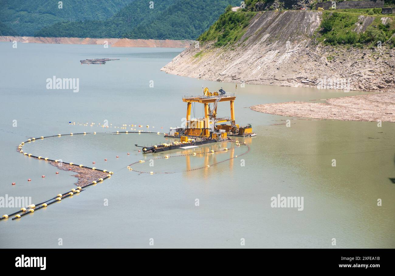 Operational industrial crane on a floating platform in Enguri reservoir ...