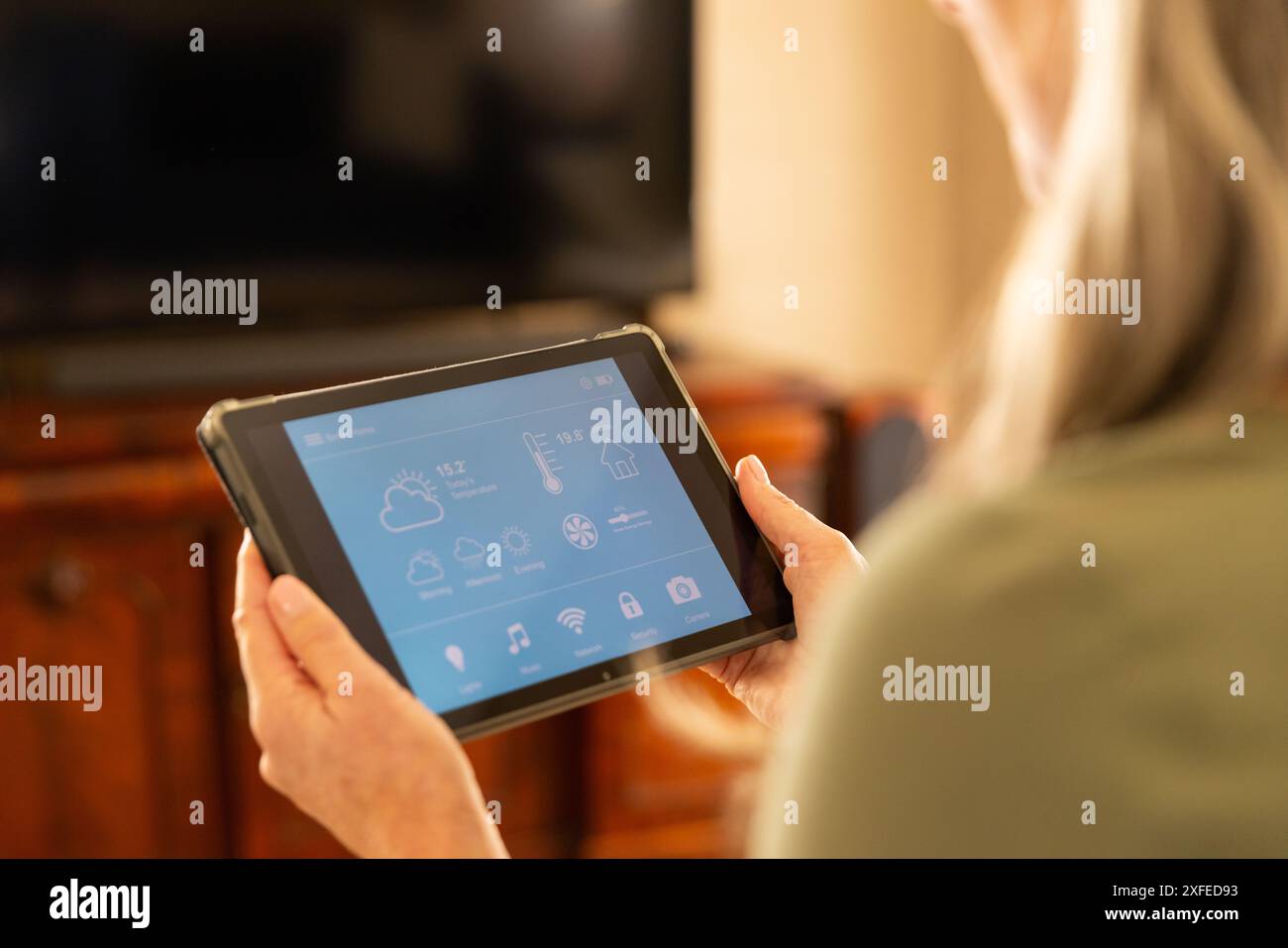 Using tablet for controlling smart home devices, woman managing home ...