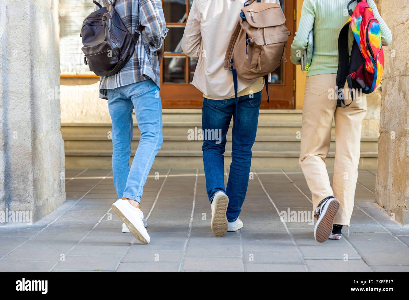 Students students walking backwards to camera after university classes ...