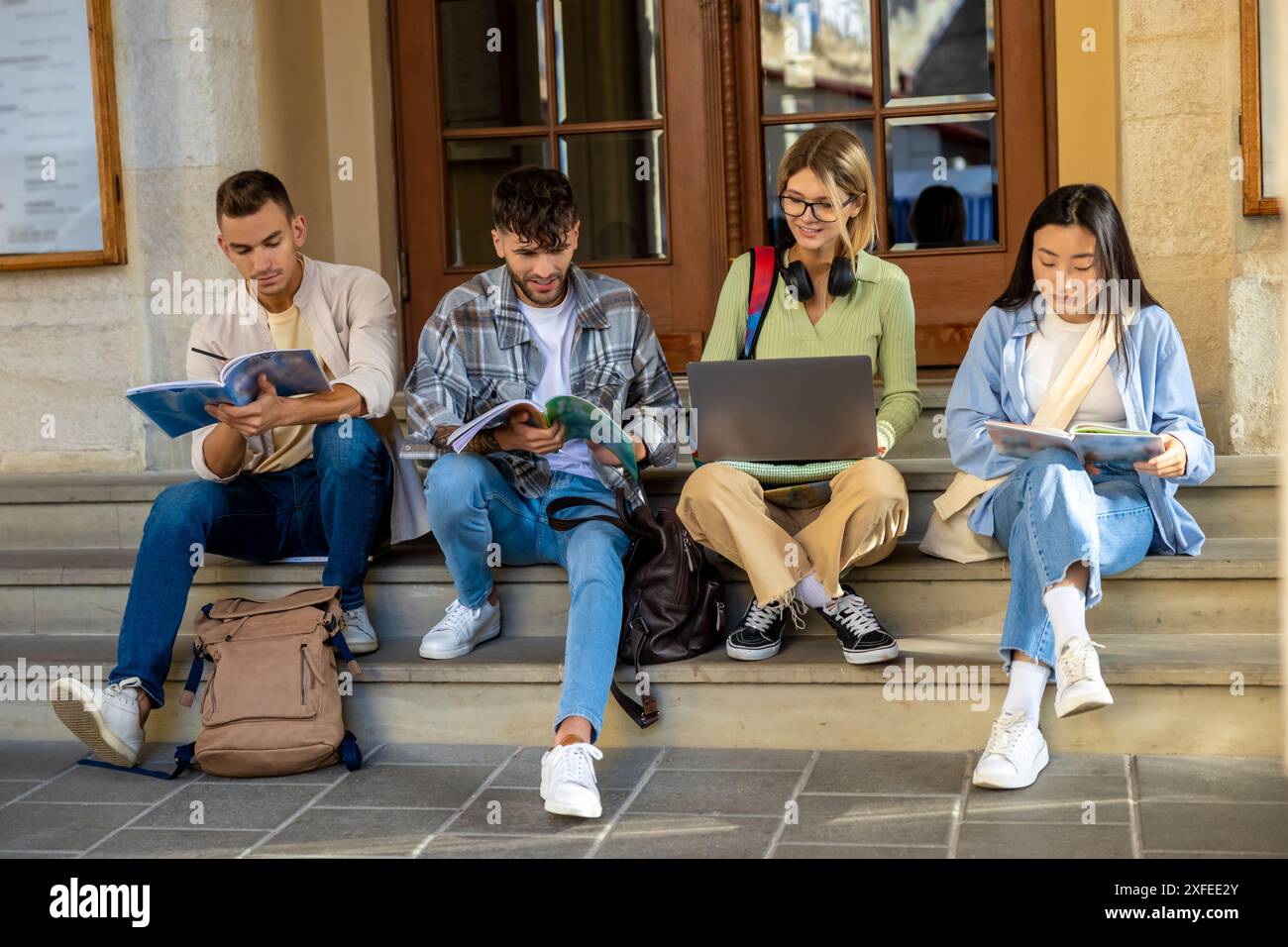 Multiethnic group of students preparing for seminar on stairs Stock ...
