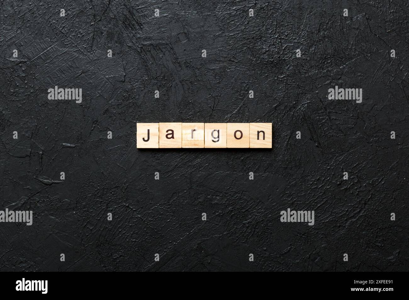 Jargon word written on wood block. Jargon text on cement table for your ...