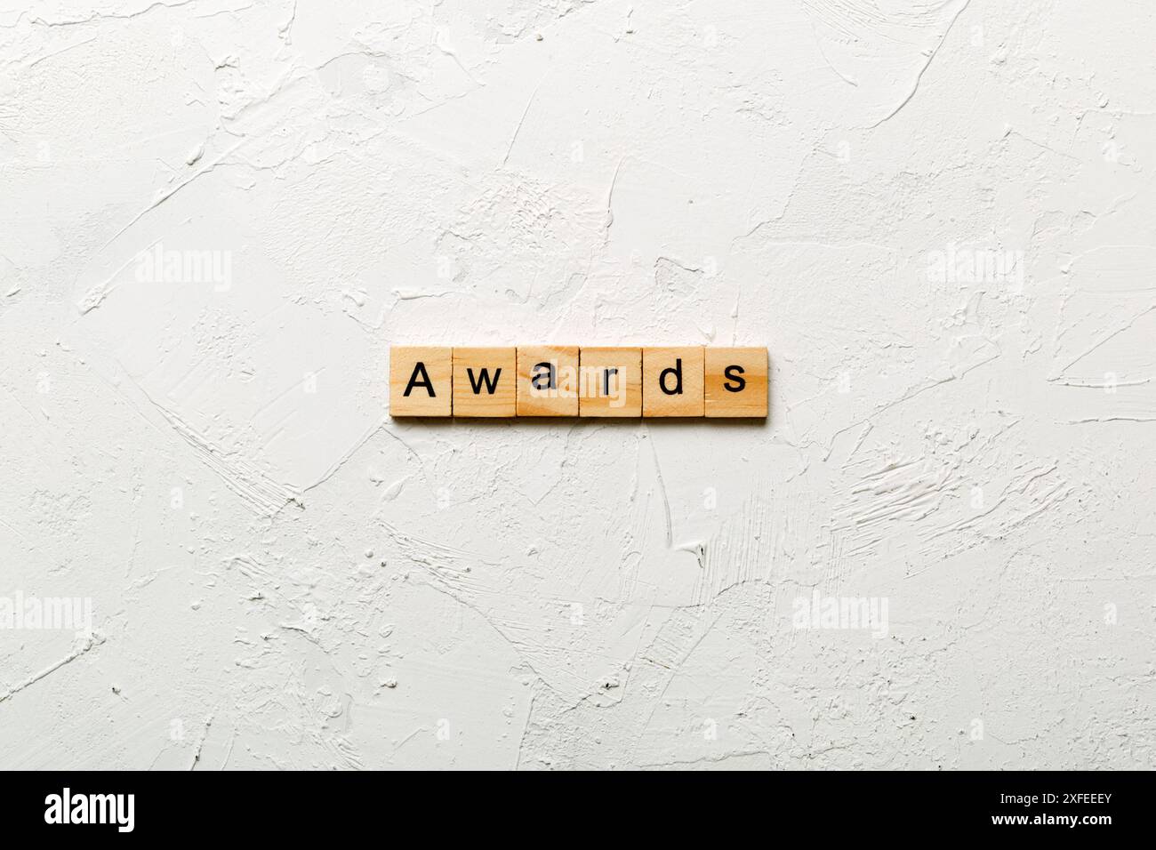 AWARDS word written on wood block. AWARDS text on cement table for your ...