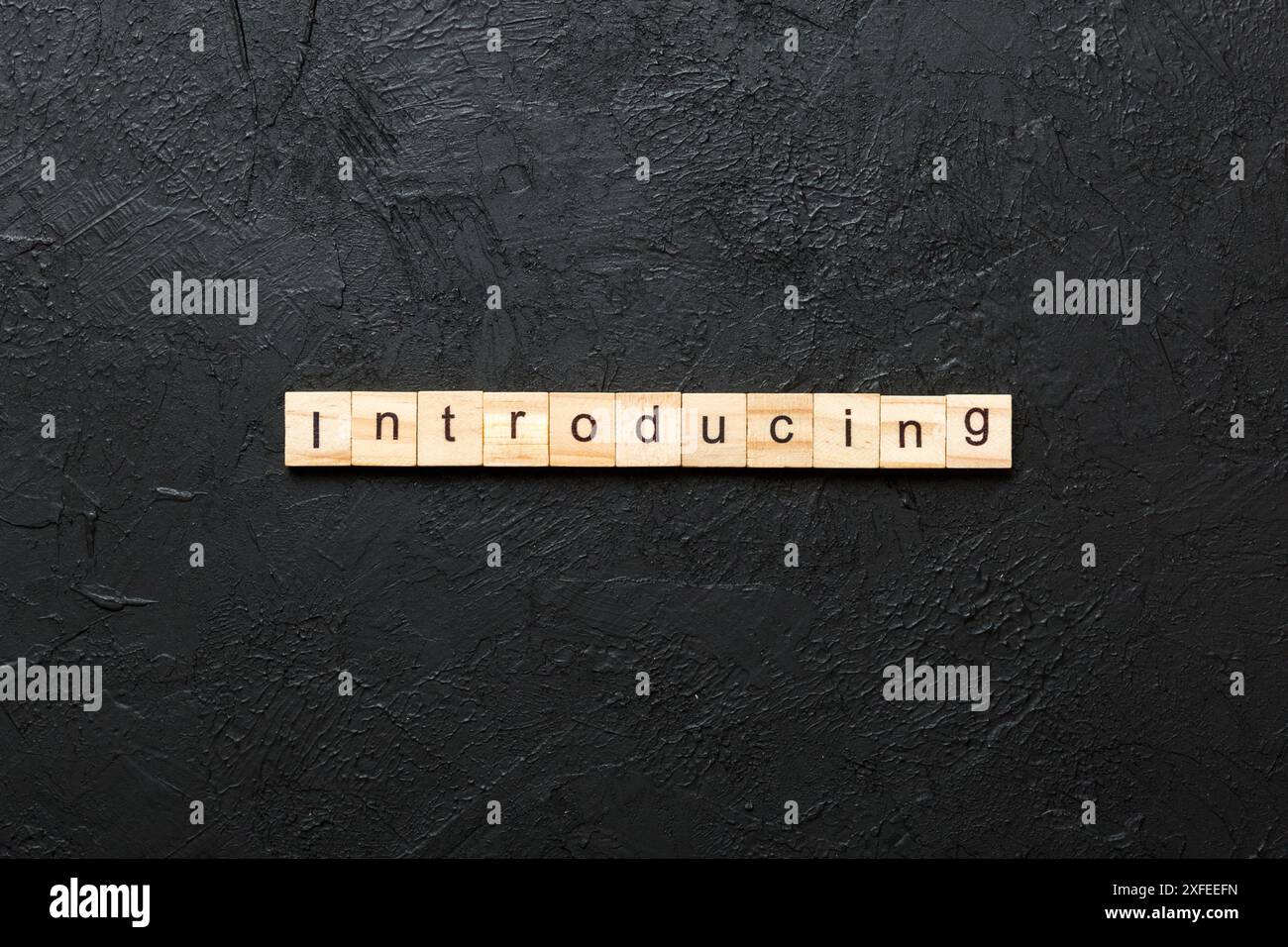 introducing word written on wood block. introducing text on table ...