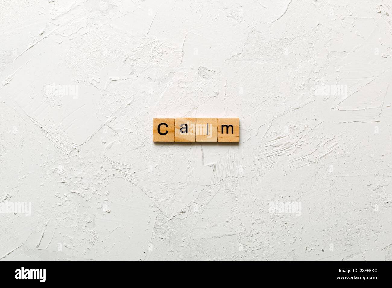 calm word written on wood block. calm text on cement table for your ...