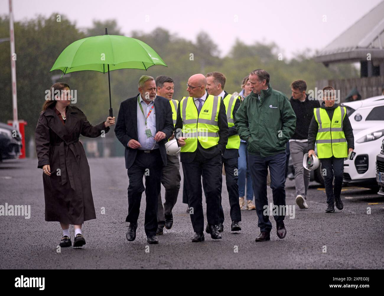 Scottish First Minister and SNP leader John Swinney (centre) and ...