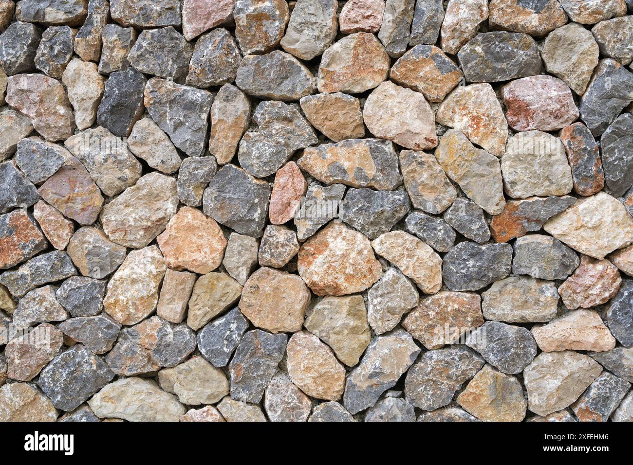 Flat lay photograph of a colorful stone wall. Stone background texture ...