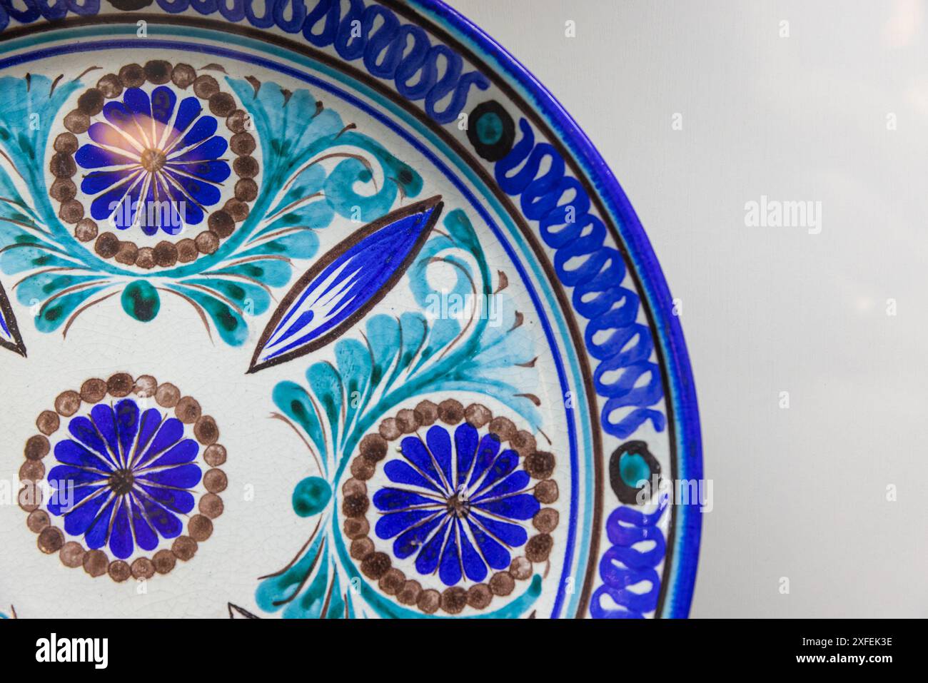 Handmade Uzbek plate with traditional colorful pattern is on white ...