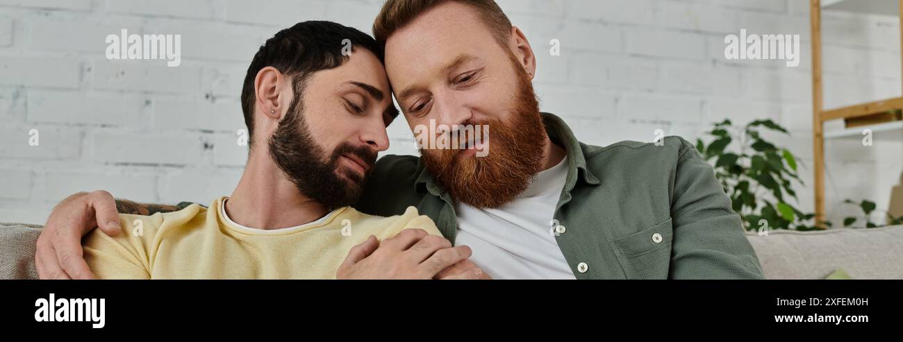 Bearded Gay Couple Enjoying Each Others Company While Sitting On Top Of A Sofa In The Living