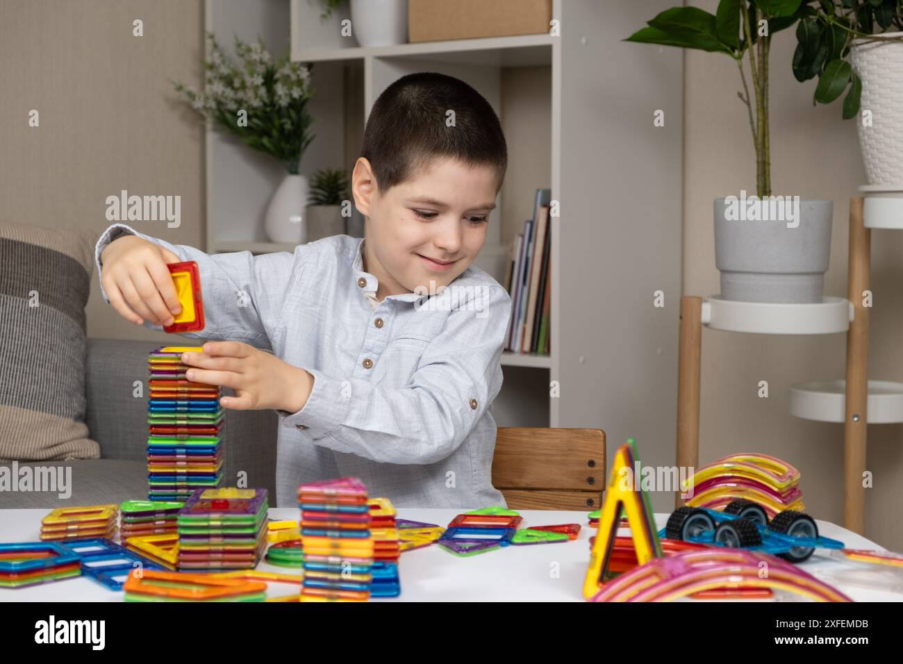 Boy building tower from magnetic hi-res stock photography and images ...