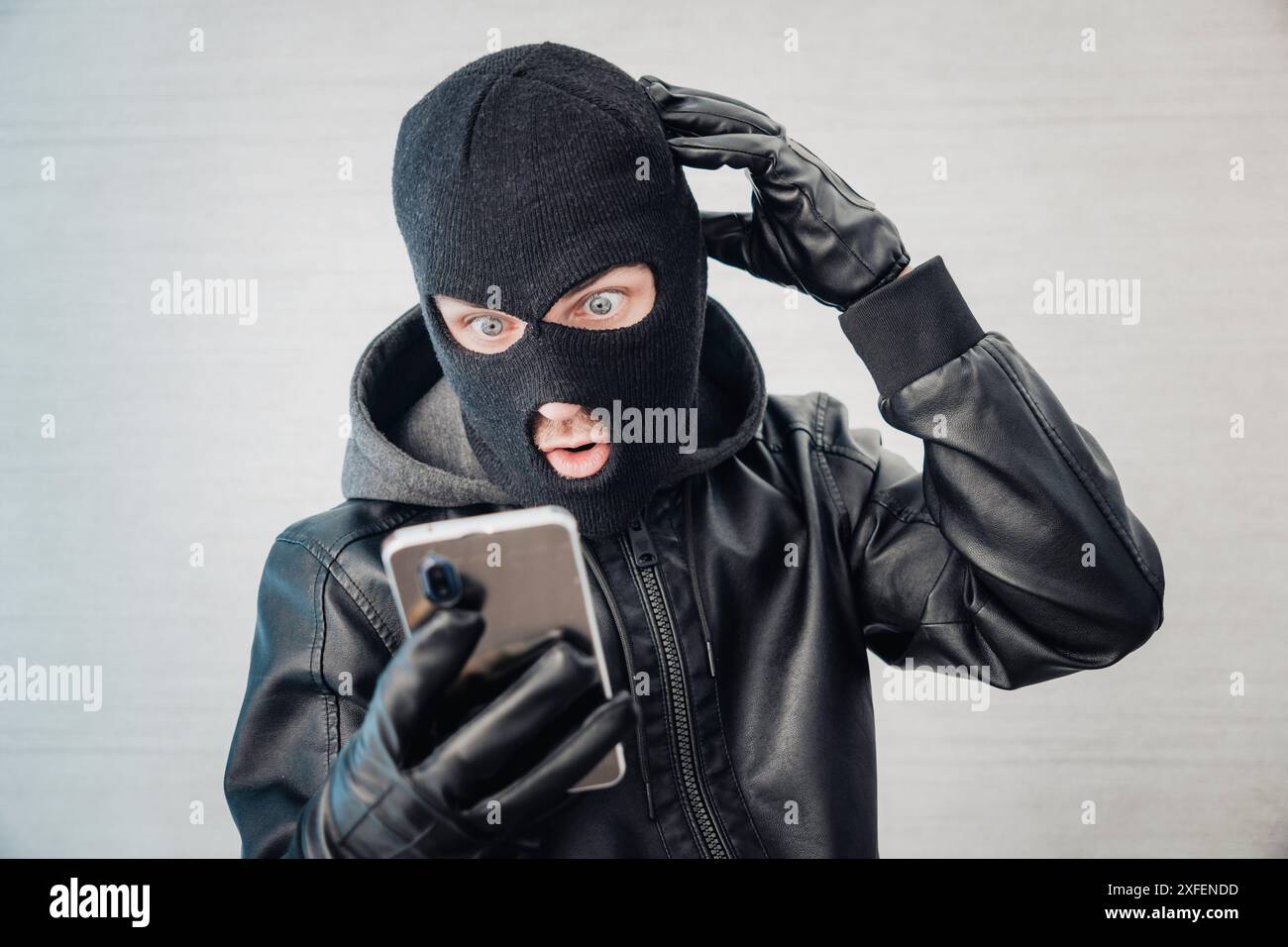 Young adult in black clothes with hidden face. Ill-intended fraudster ...