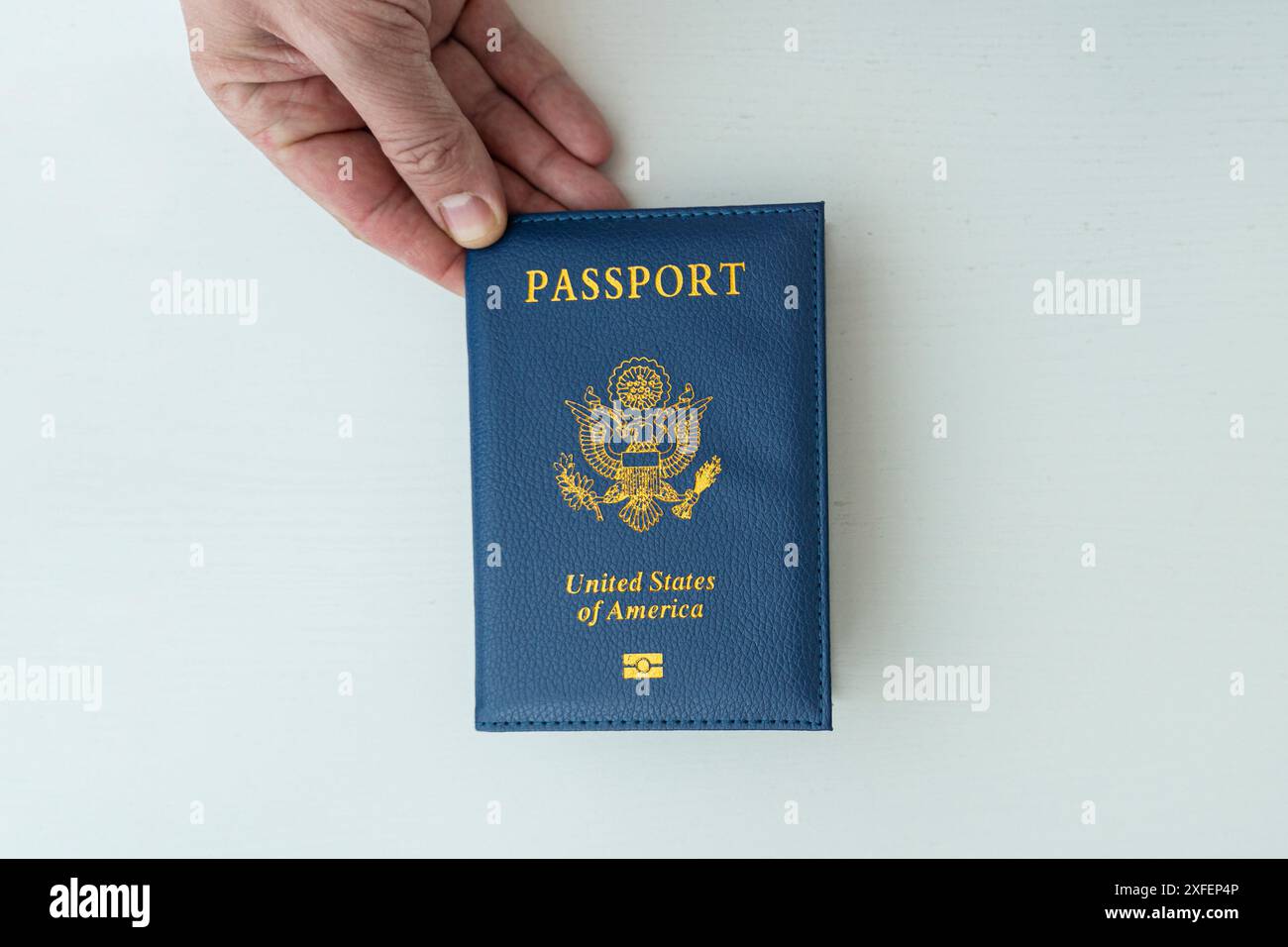 hand holding U.S. passport. issuance of an American passport, obtaining ...